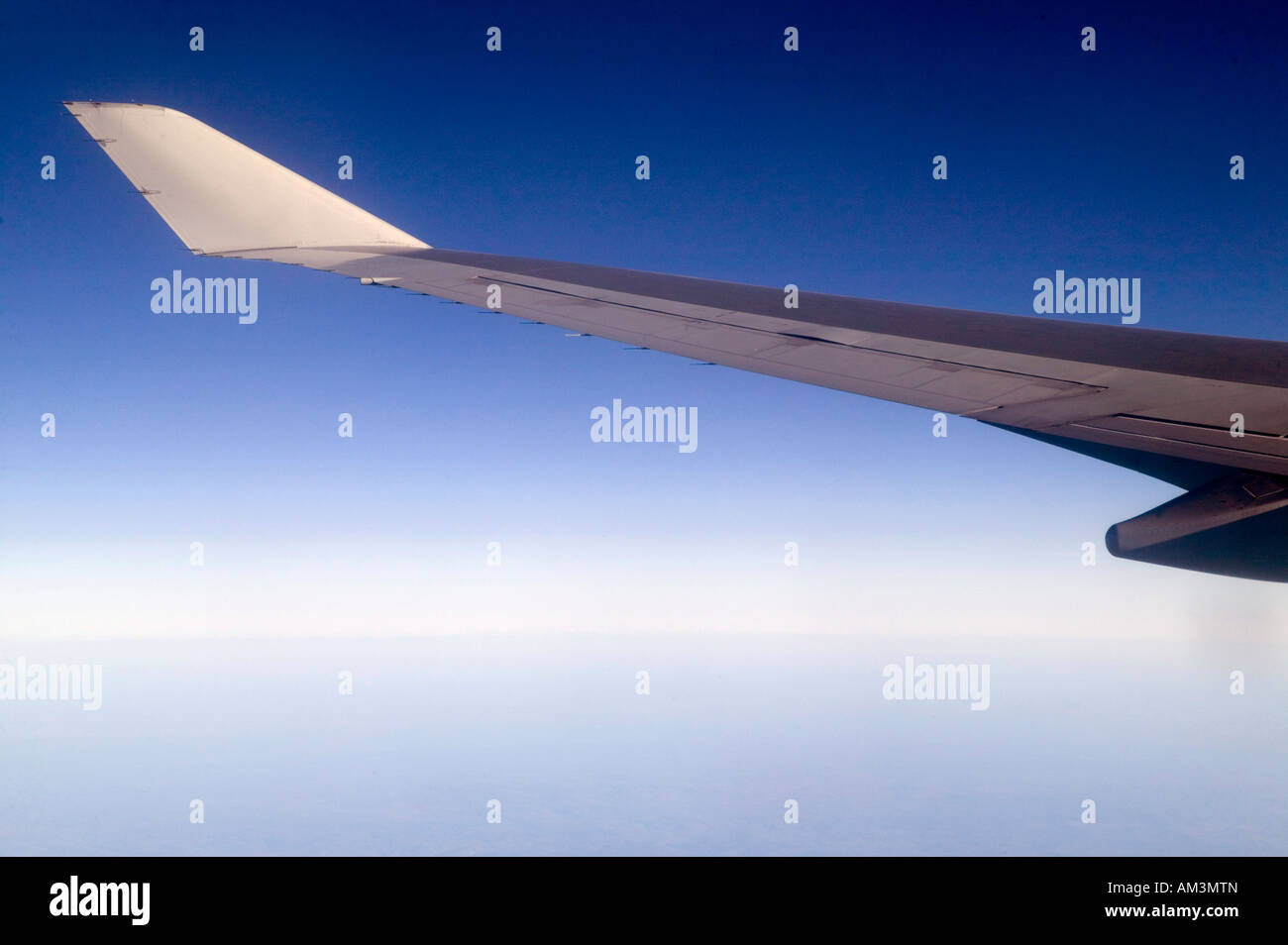 Plane s grey metal left side wing seen from a window during a flight ...