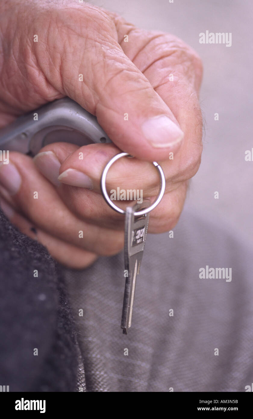 Hand holding key Stock Photo - Alamy