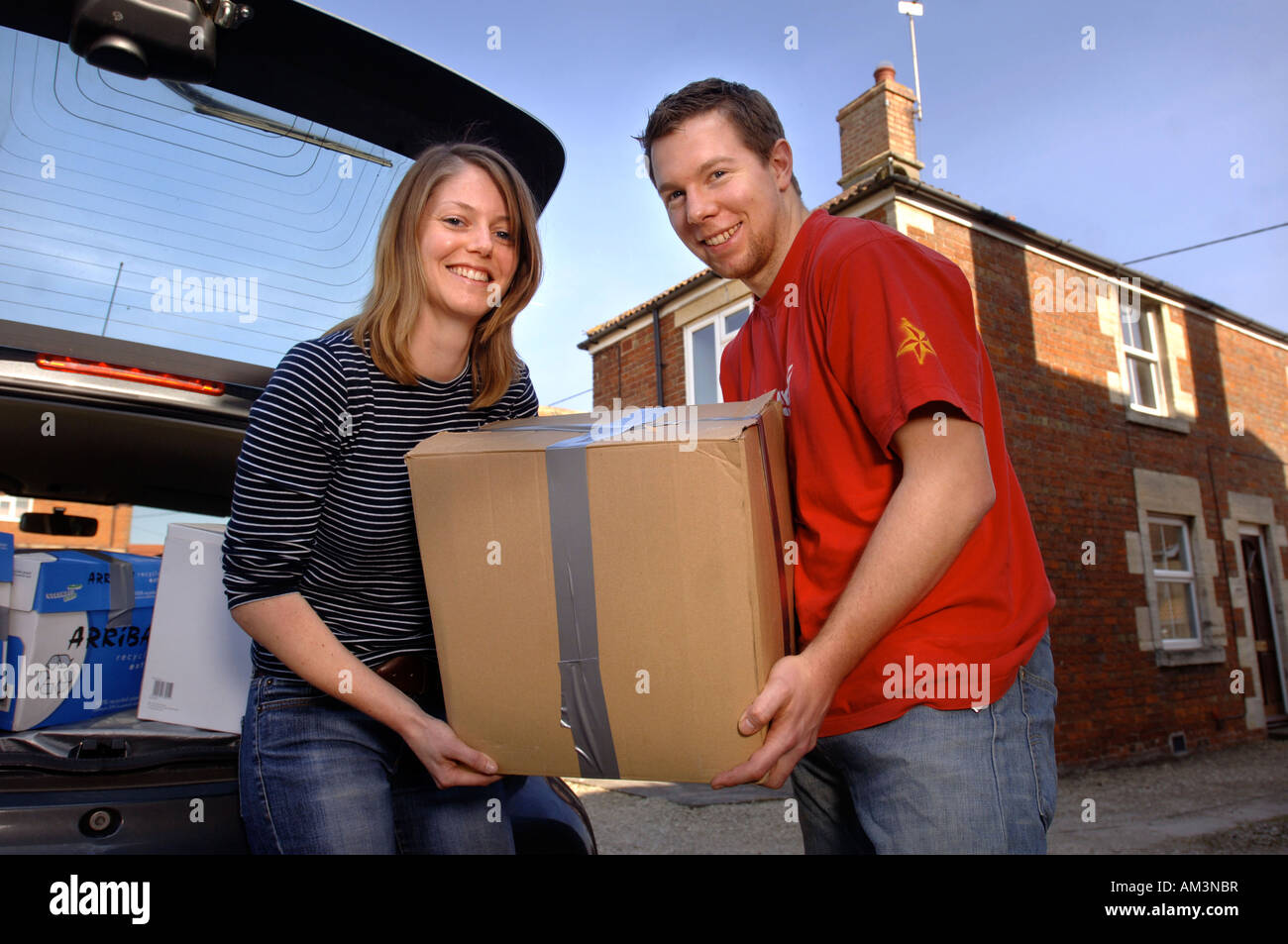 A YOUNG COUPLE MOVING INTO THEIR FIRST HOME UK Stock Photo - Alamy
