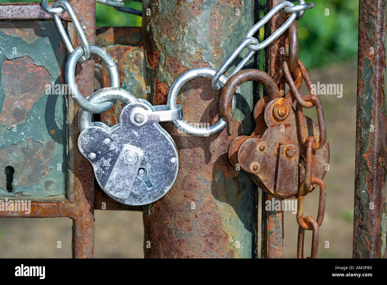 close up shiny new padlock alongside rusty old pad lock Stock Photo - Alamy