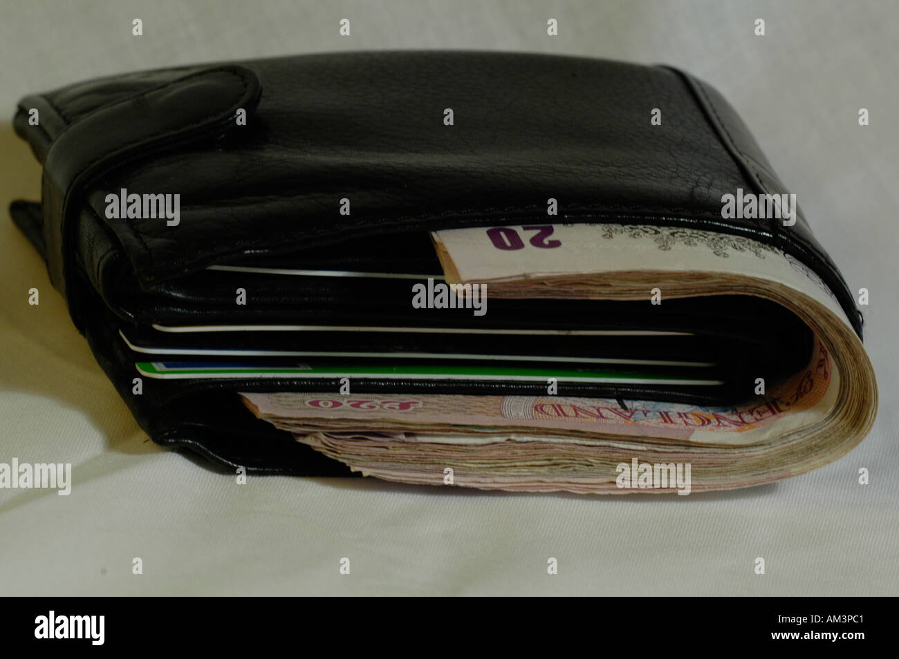 a large wallet stuffed with money Stock Photo - Alamy
