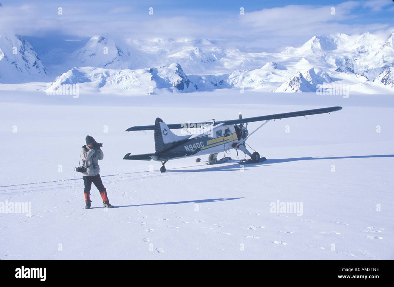Photographer Joe Sohm taking photographs on glacier in Alaska while ...