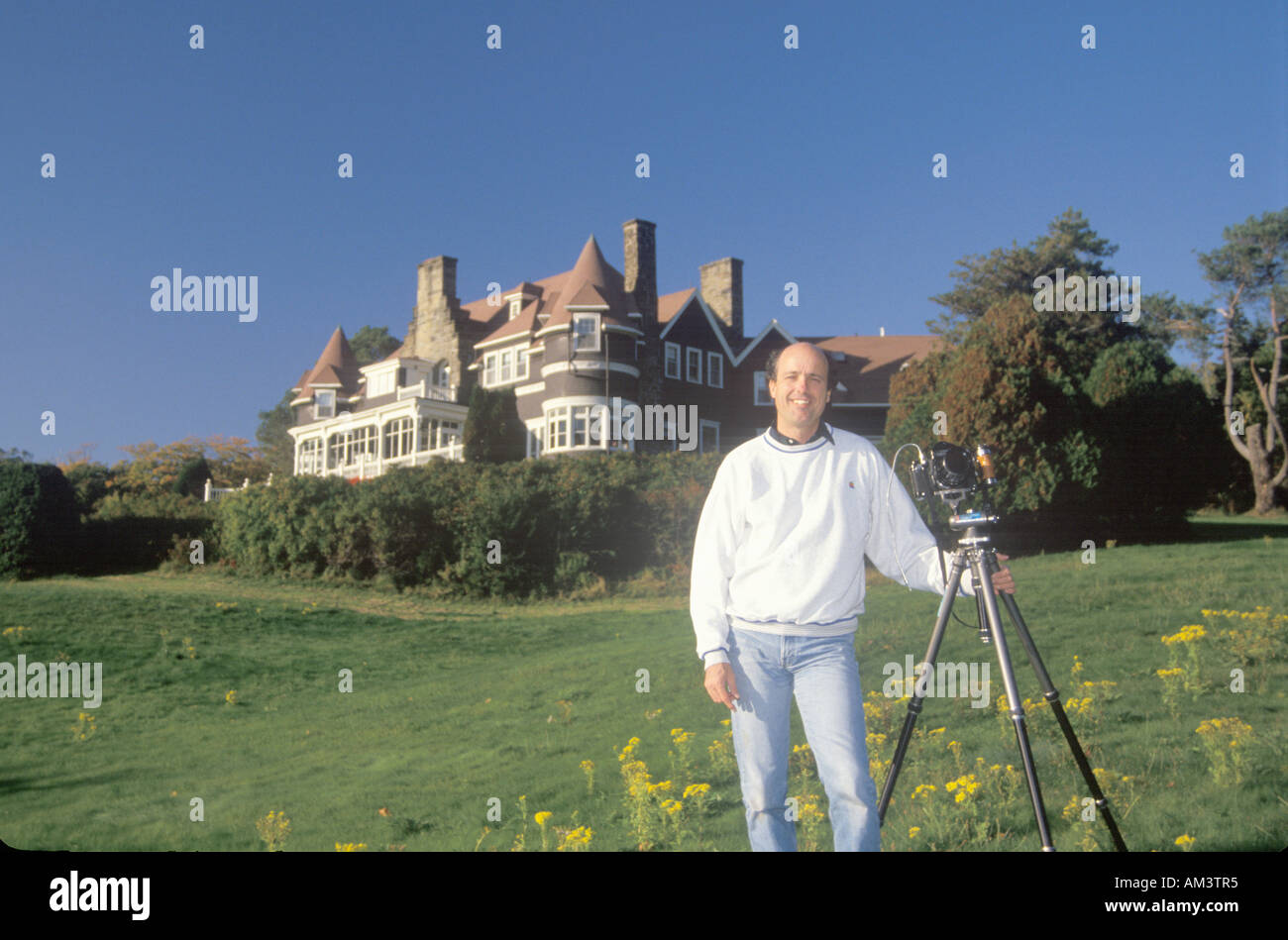 Photographer Joe Sohm posing with panoramic camera in front of home of ...