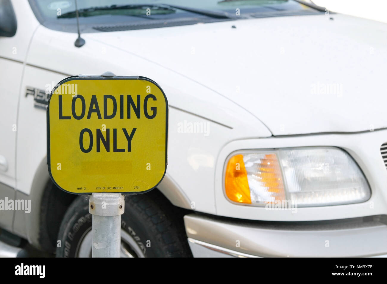 Loading only sign next to car Stock Photo - Alamy