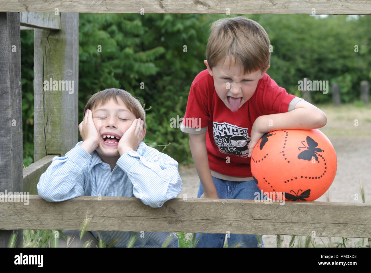 Two boys pulling faces Stock Photo - Alamy