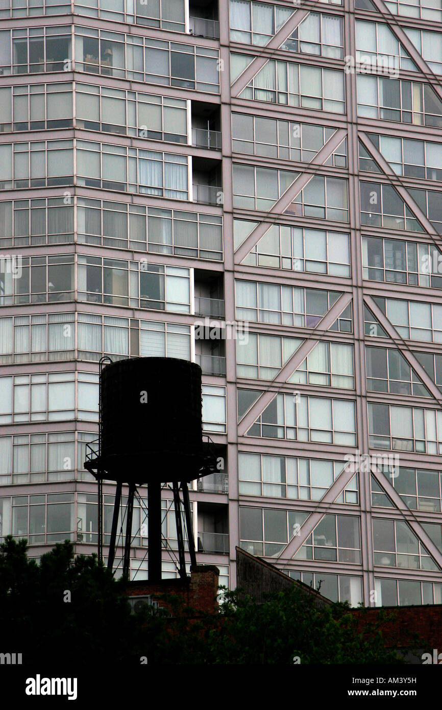 Water tower in silhouette in front of skyscraper Stock Photo - Alamy