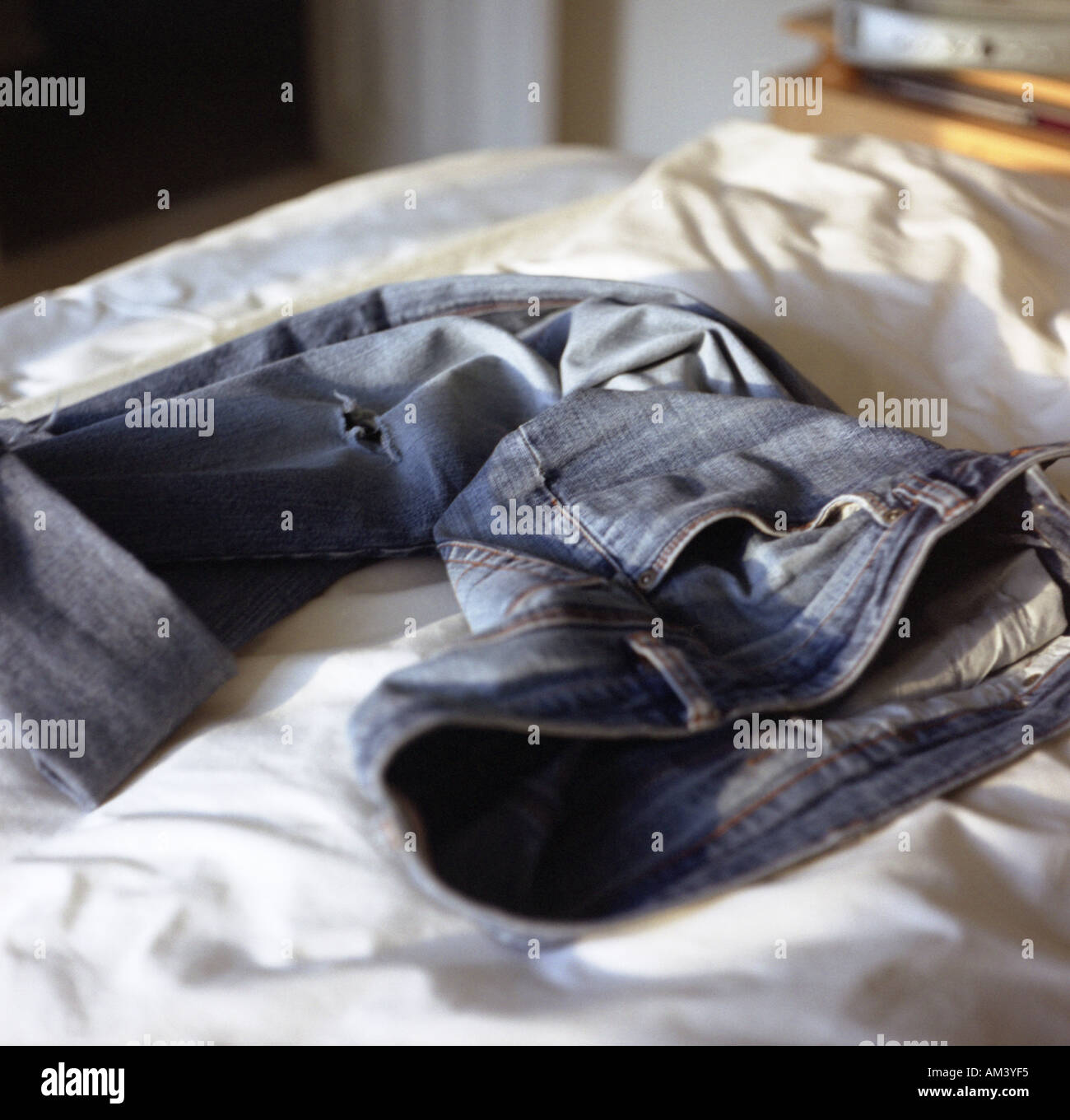 Crumpled Jeans on a Bed Stock Photo - Alamy