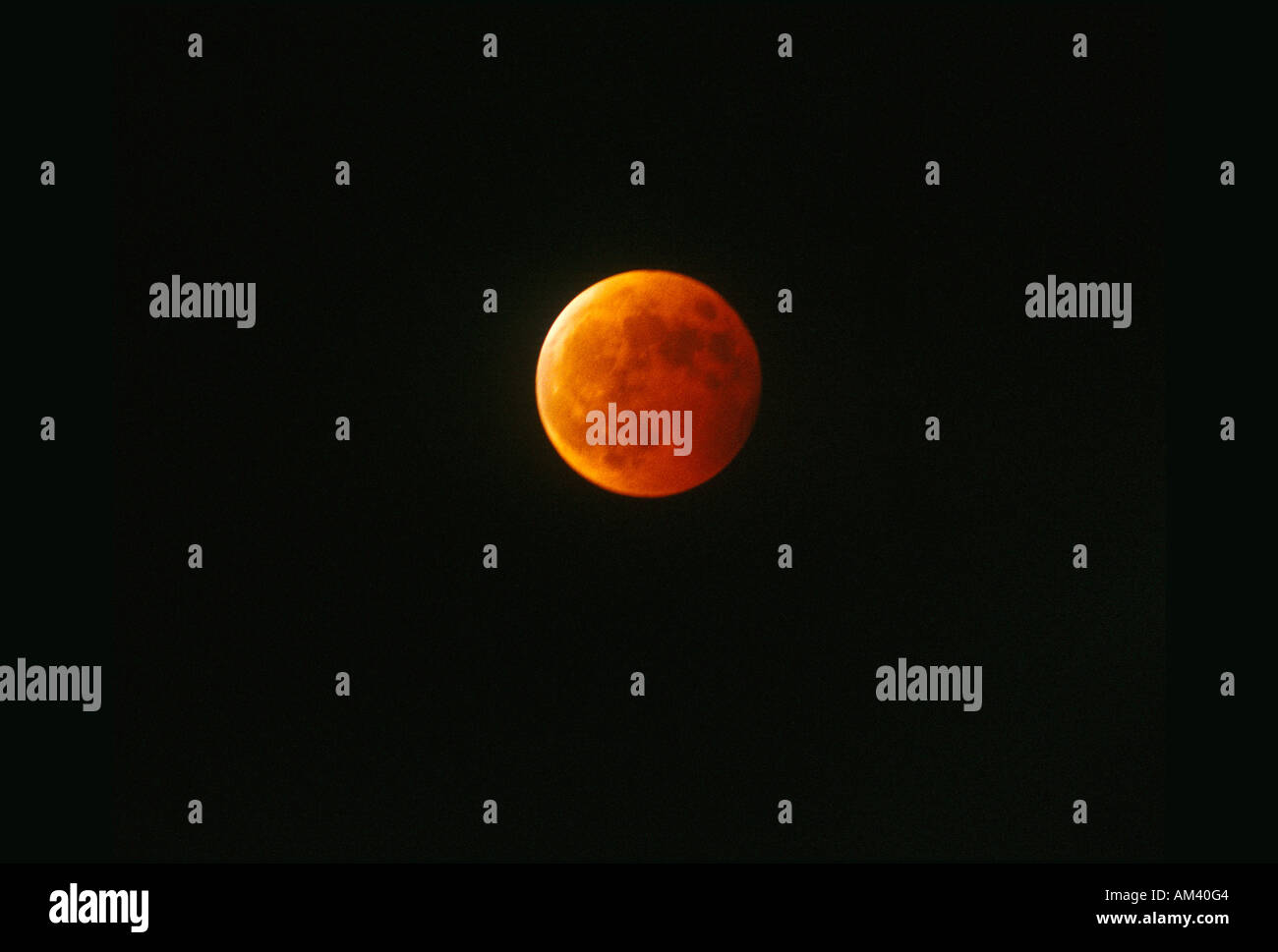 A full moon mostly covered by Earth s shadow during a lunar eclipse ...