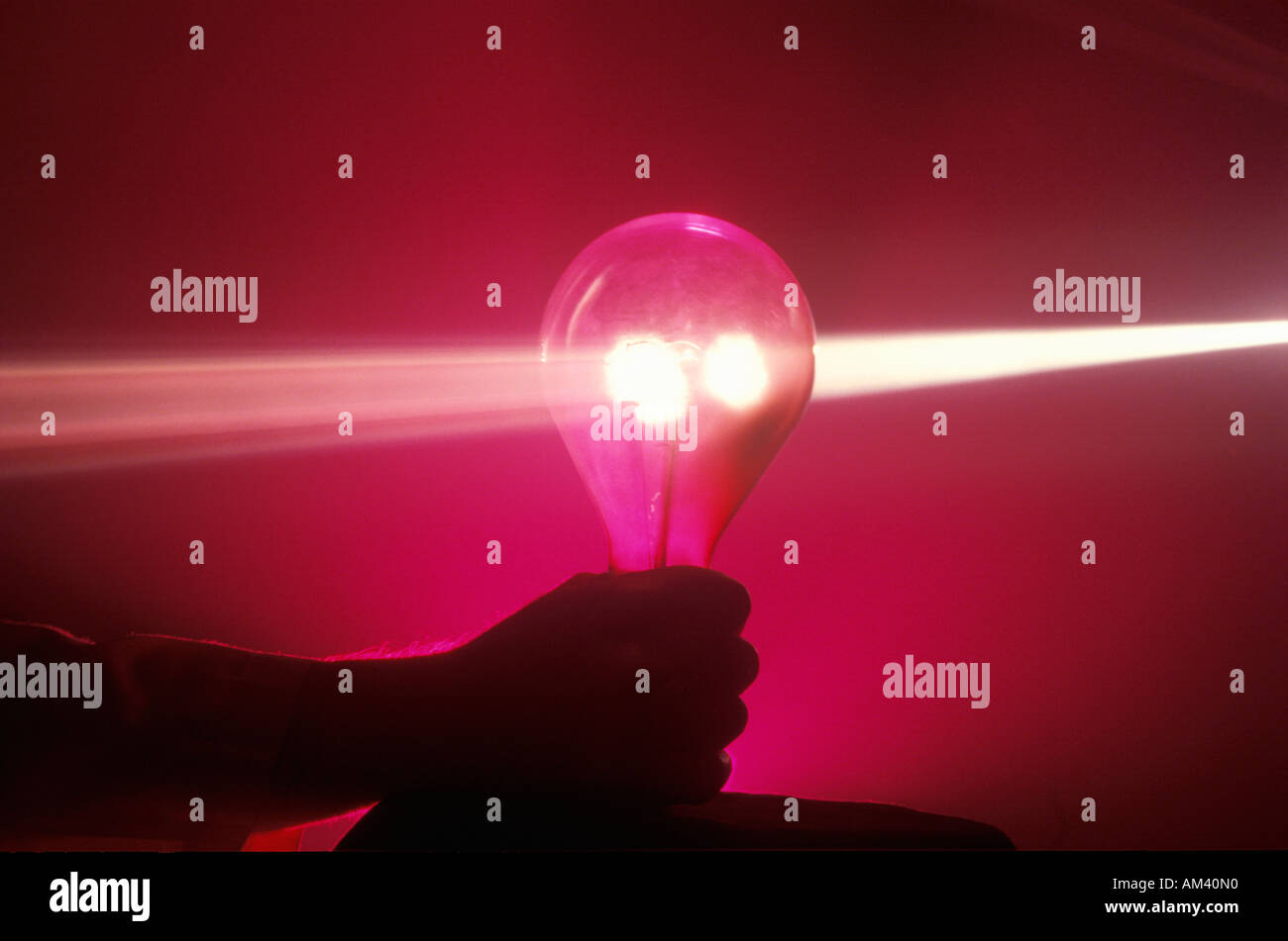 A lightbulb illuminated with a beam of light colors from a laser Stock ...