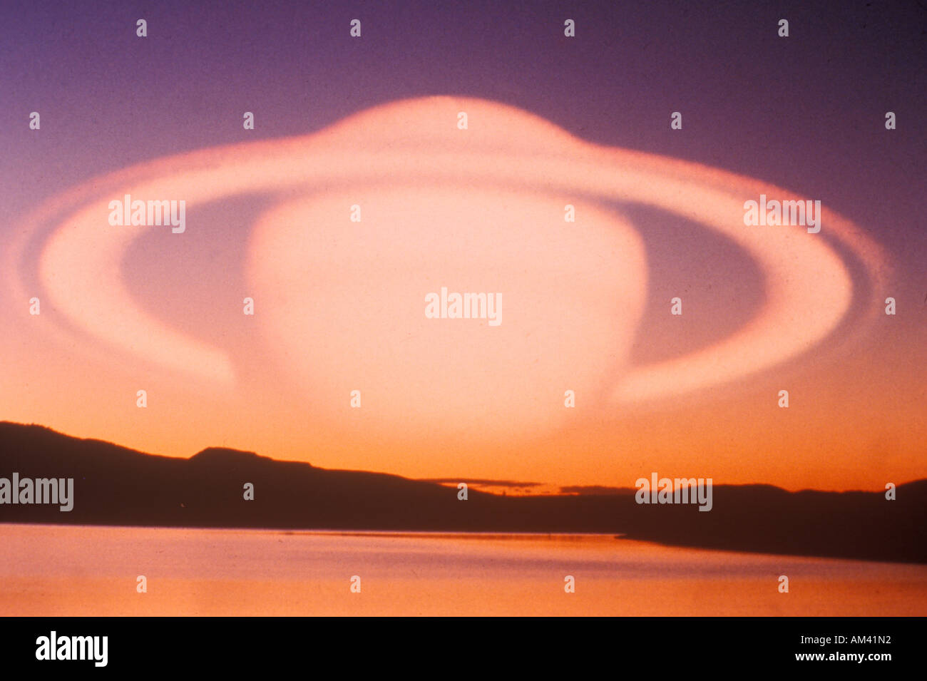 Saturn superimposed on a colorful sunset sky Stock Photo - Alamy