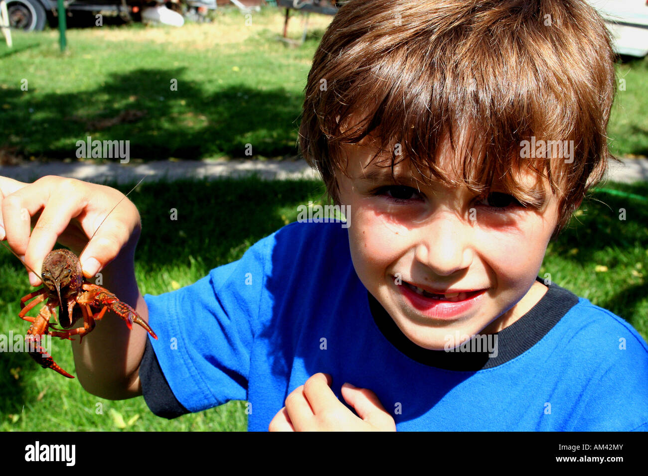 Young Boy Holding a Crawdad Stock Photo - Alamy