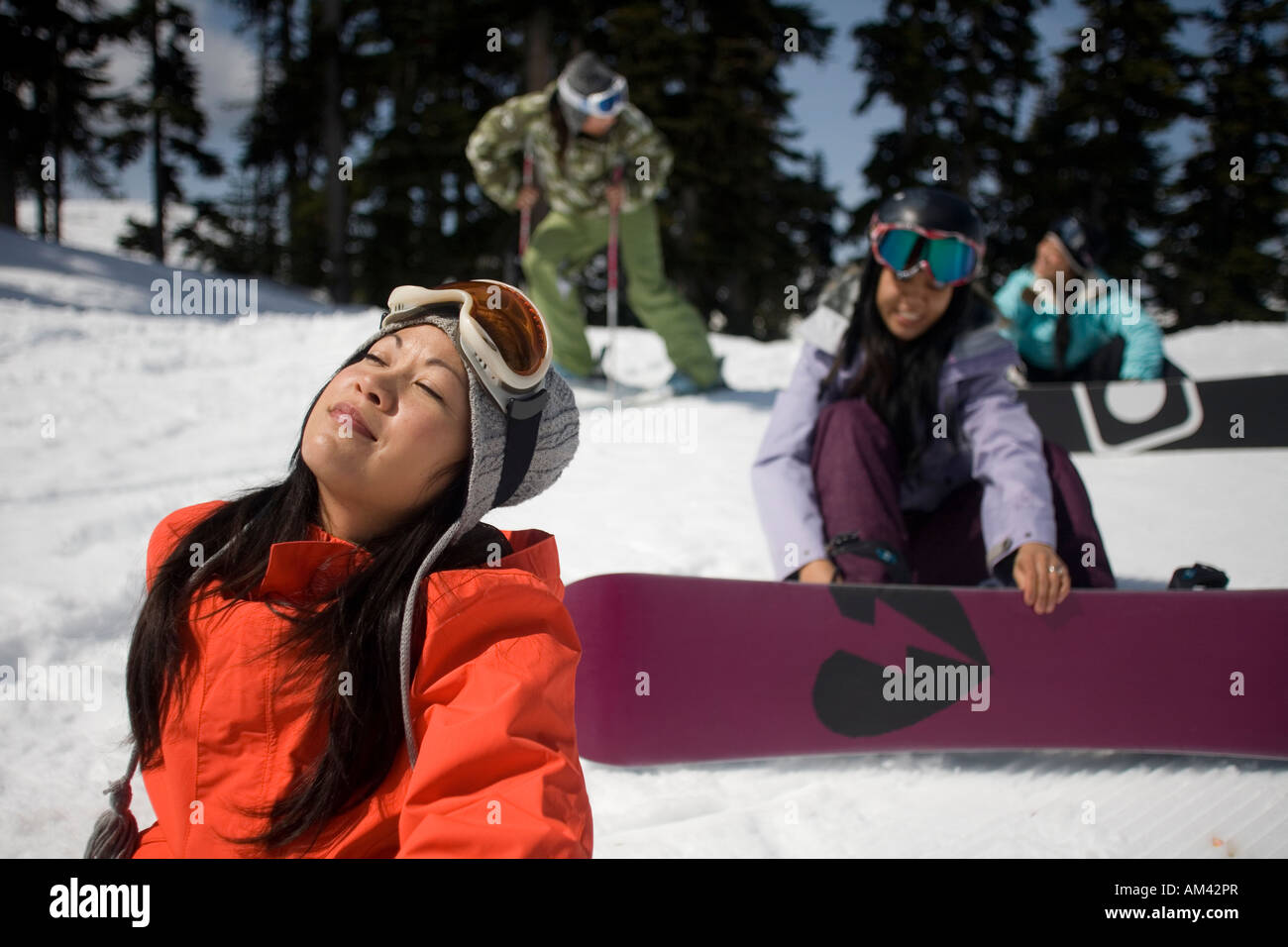 Young asian female skiers and snowboarders Whistler Mountain British ...