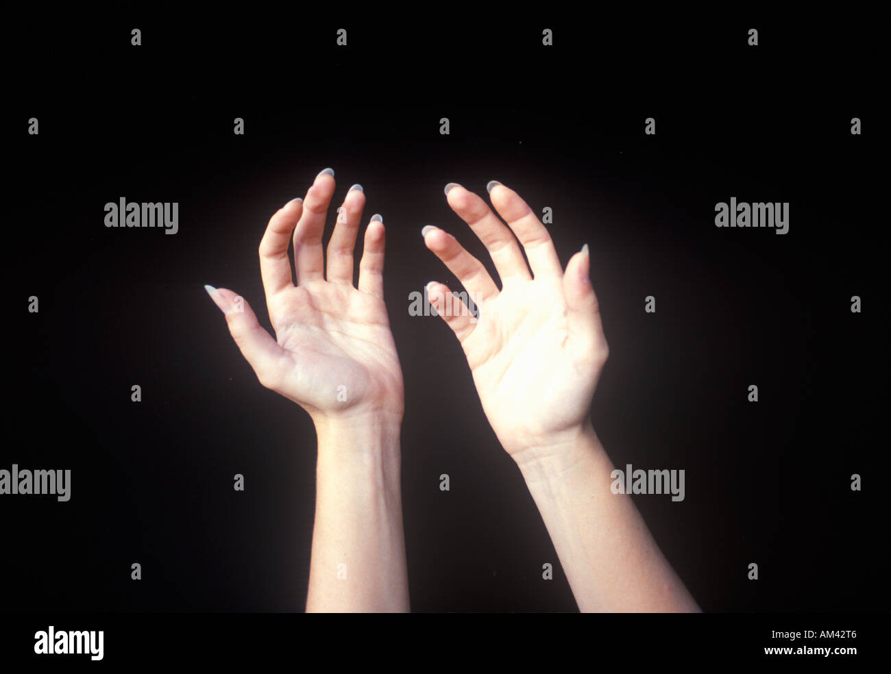 Special effects composite of two hands and black sky Stock Photo - Alamy