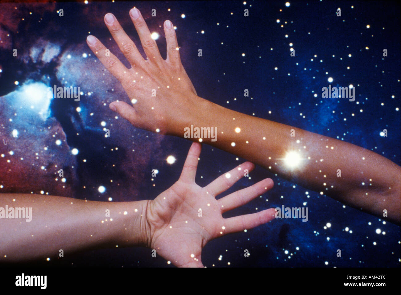 Special effects composite of two hands and starry sky Stock Photo - Alamy