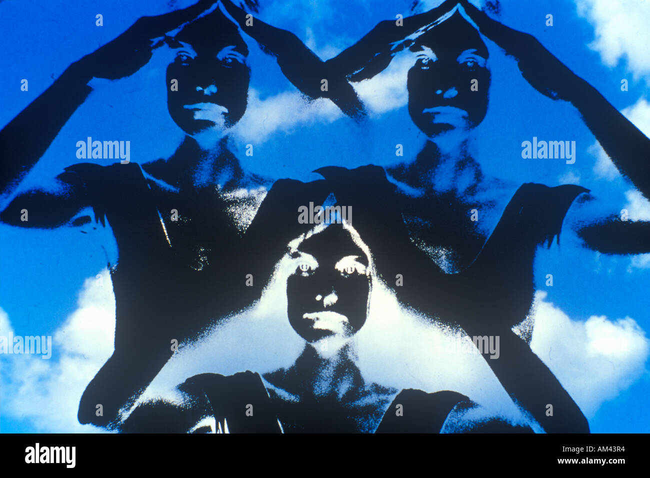 Special effects composite of dancer posing silhouetted against blue ...