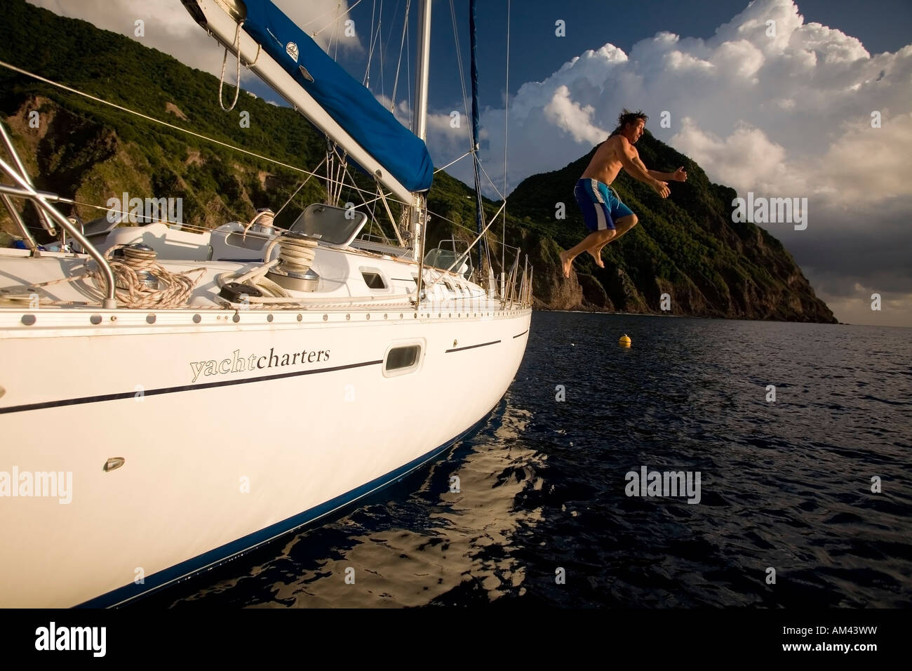 man jumping from yacht while sailing in Antigua West Indies Caribean ...