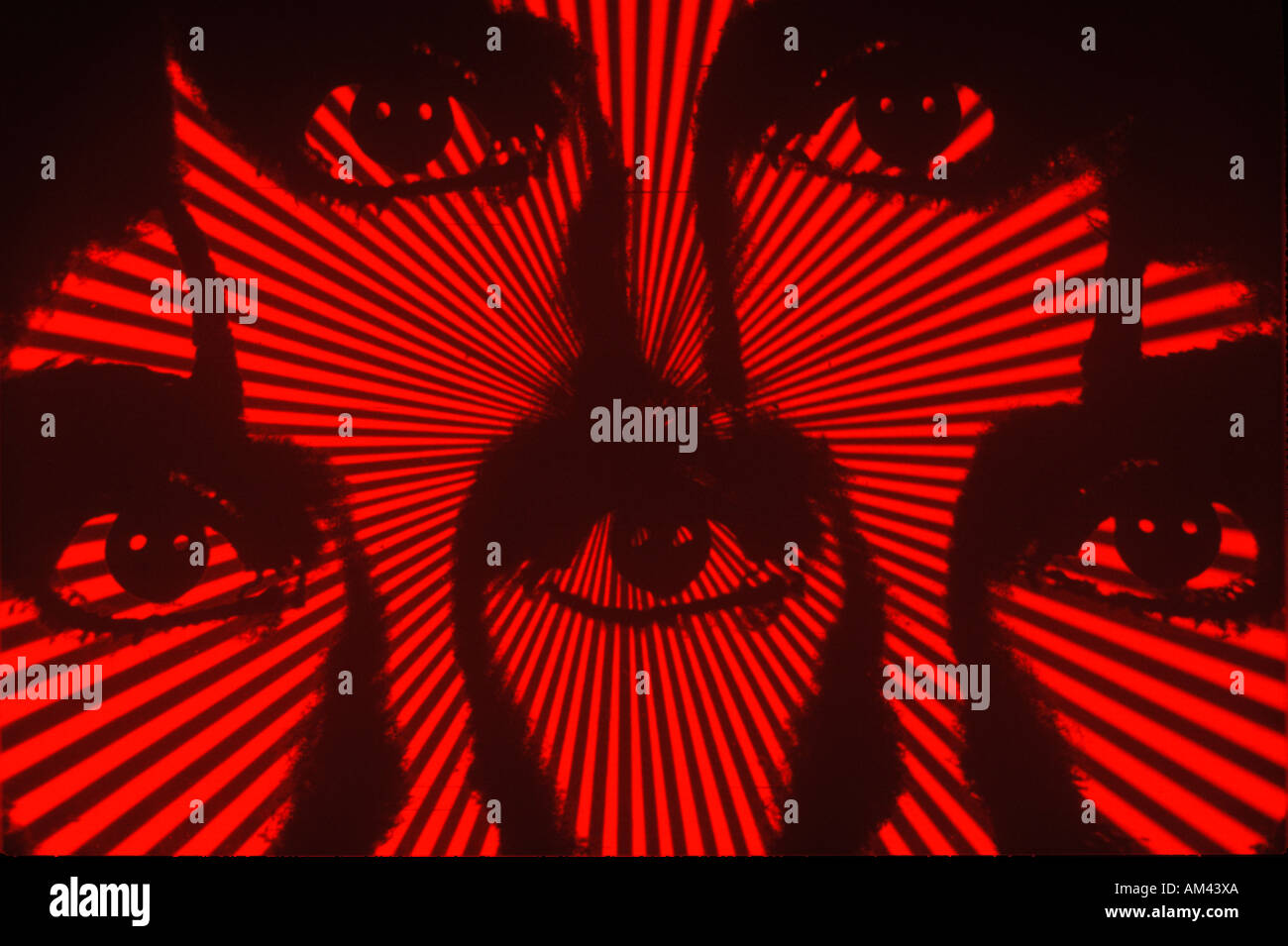 Special effects composite of several eyes in black over a radiant red ...