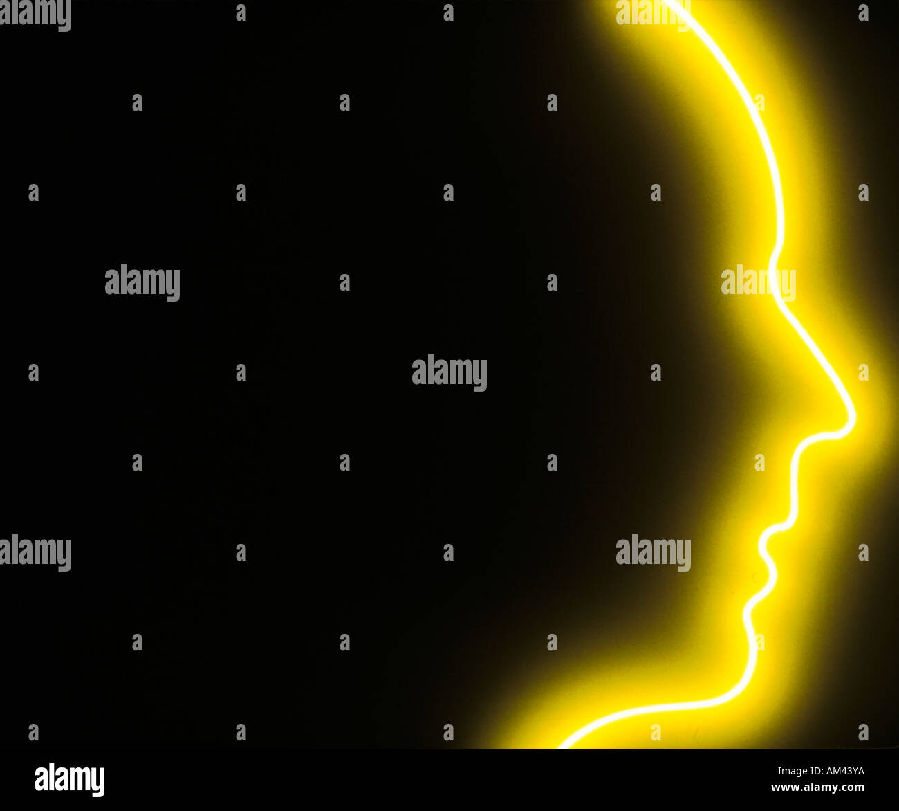 A glowing yellow outline of a face Stock Photo - Alamy