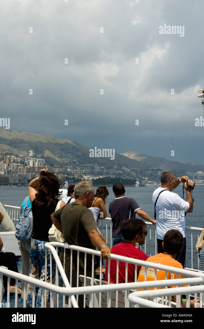 Tourists on the deck of a ferry crossing the straits of Messina Stock ...