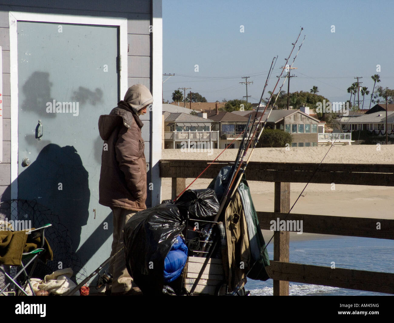Homeless man fishing from the Seal Beach Pier in Seal Beach, California ...