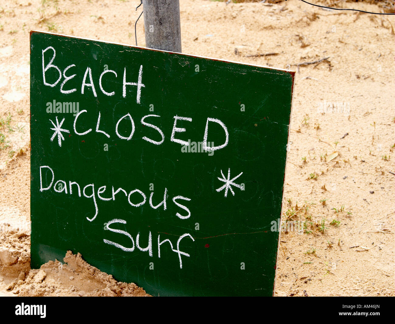 A sign indicating that a surf beach is closed due to dangerous ...