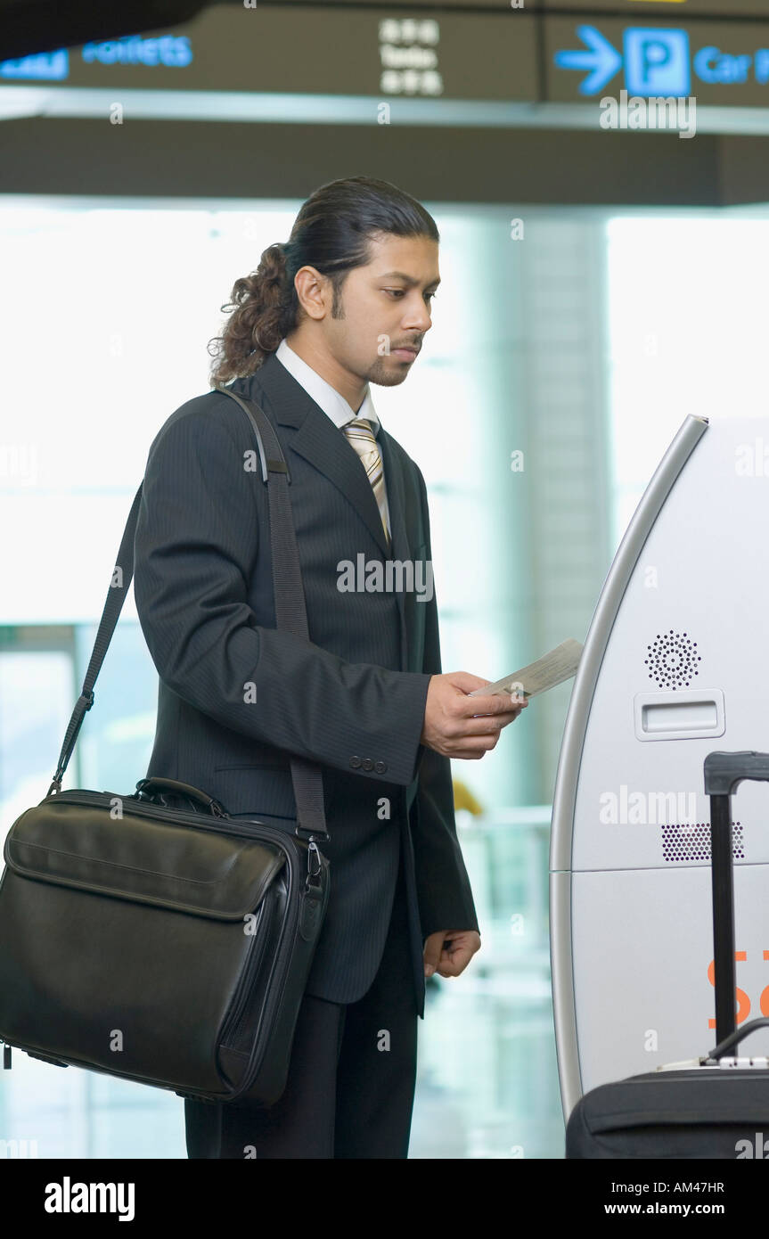 Businessman using express check-in service at an airport Stock Photo ...