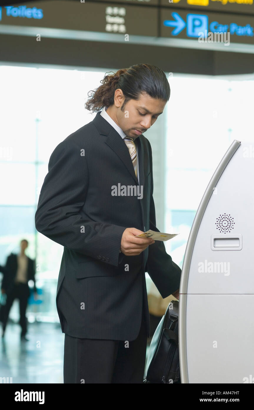 Businessman using express check-in service at an airport Stock Photo ...