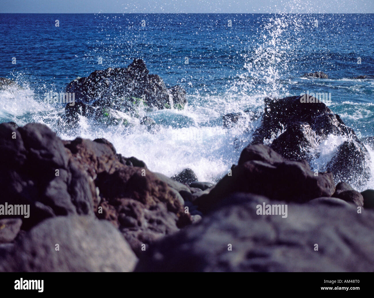 Waves splashing against the rocks in Madeira, an island belonging to ...