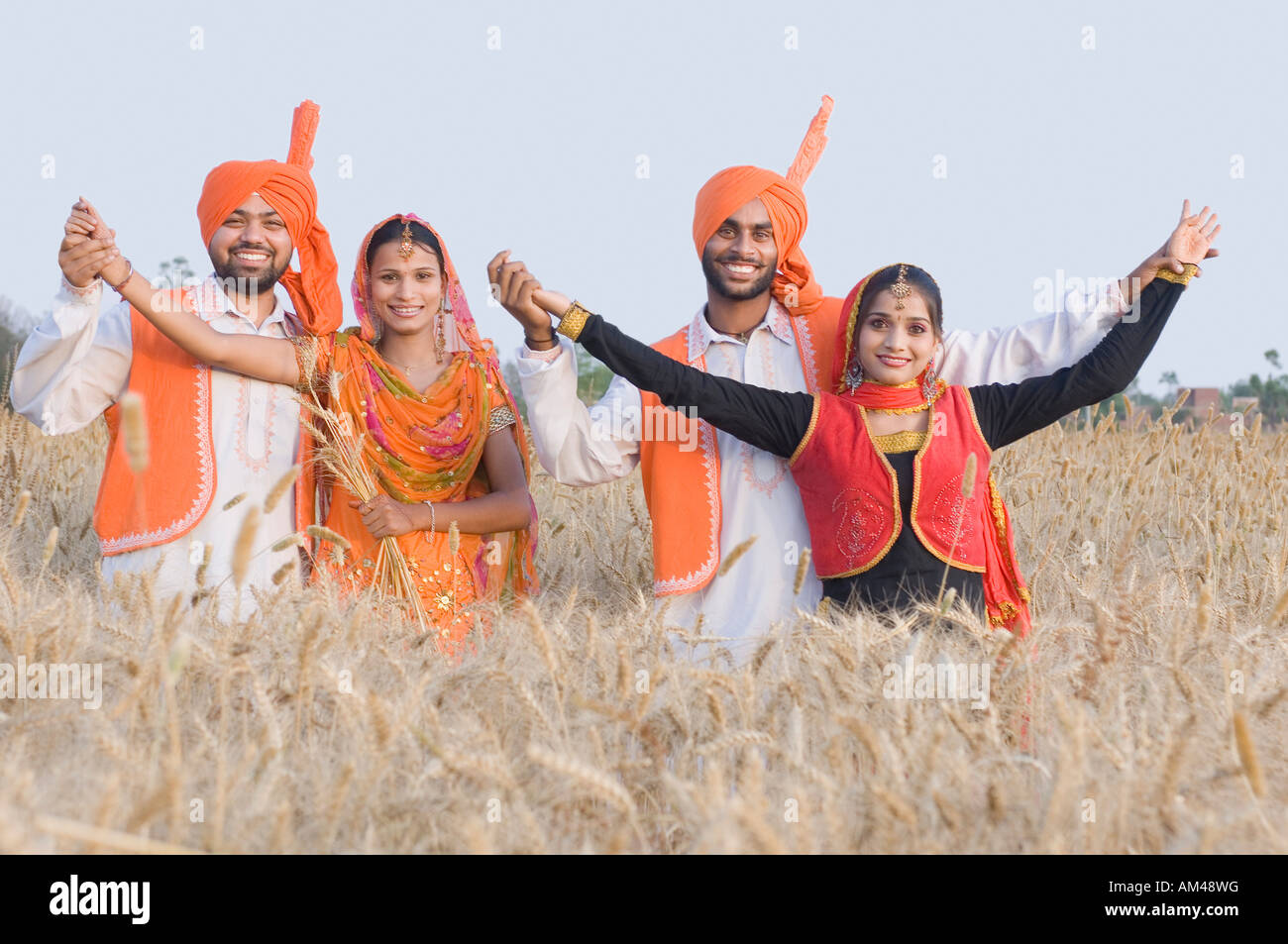 Portrait of two young couples dancing in a wheat field Stock Photo - Alamy
