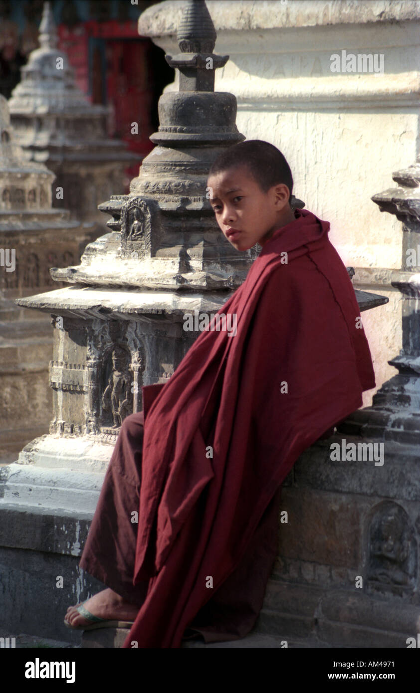 A young tibetan monk in Nepal does not look very happy about being ...
