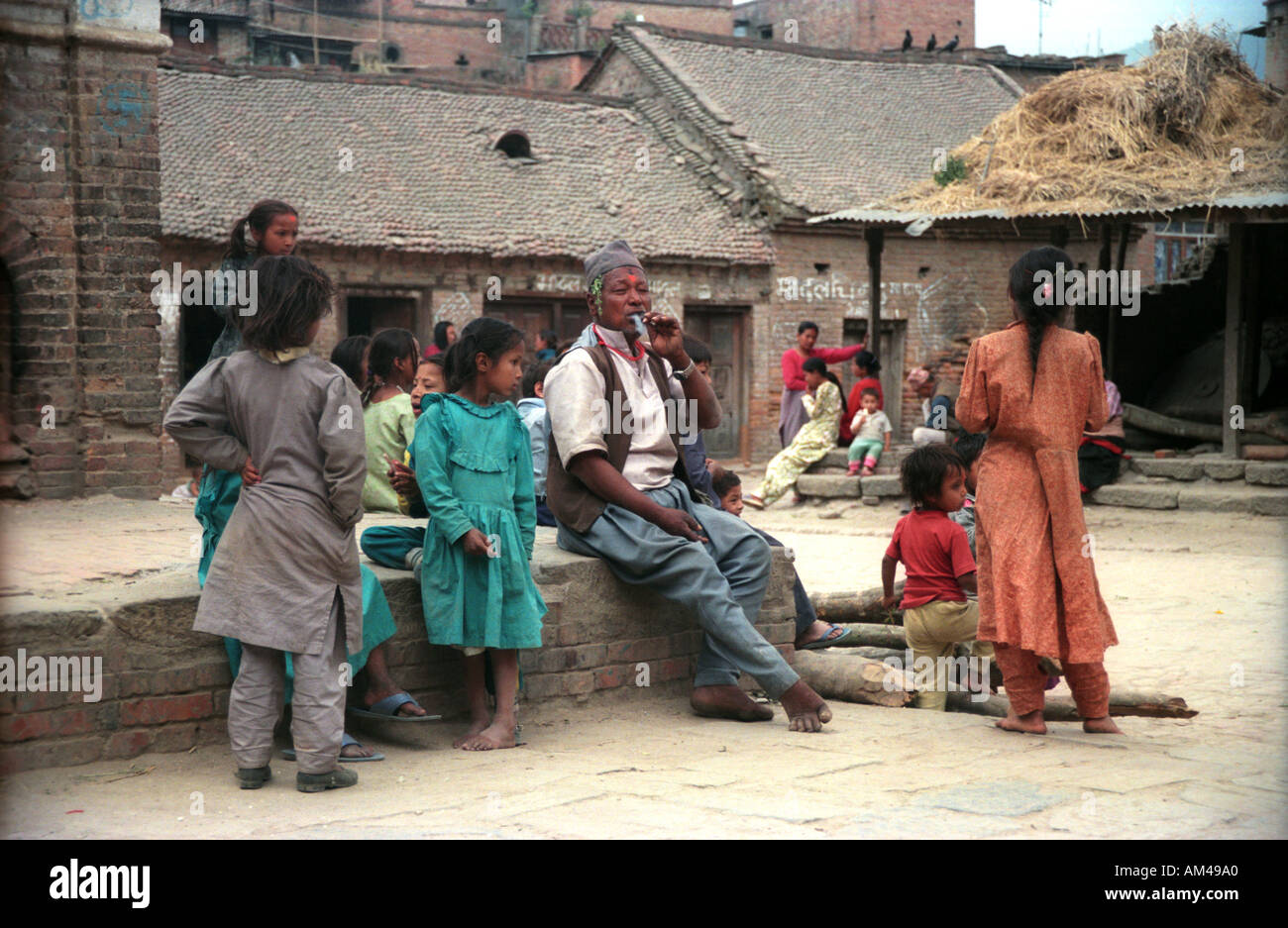 A father and his children sit in the streets of Kathmandu in Nepal ...