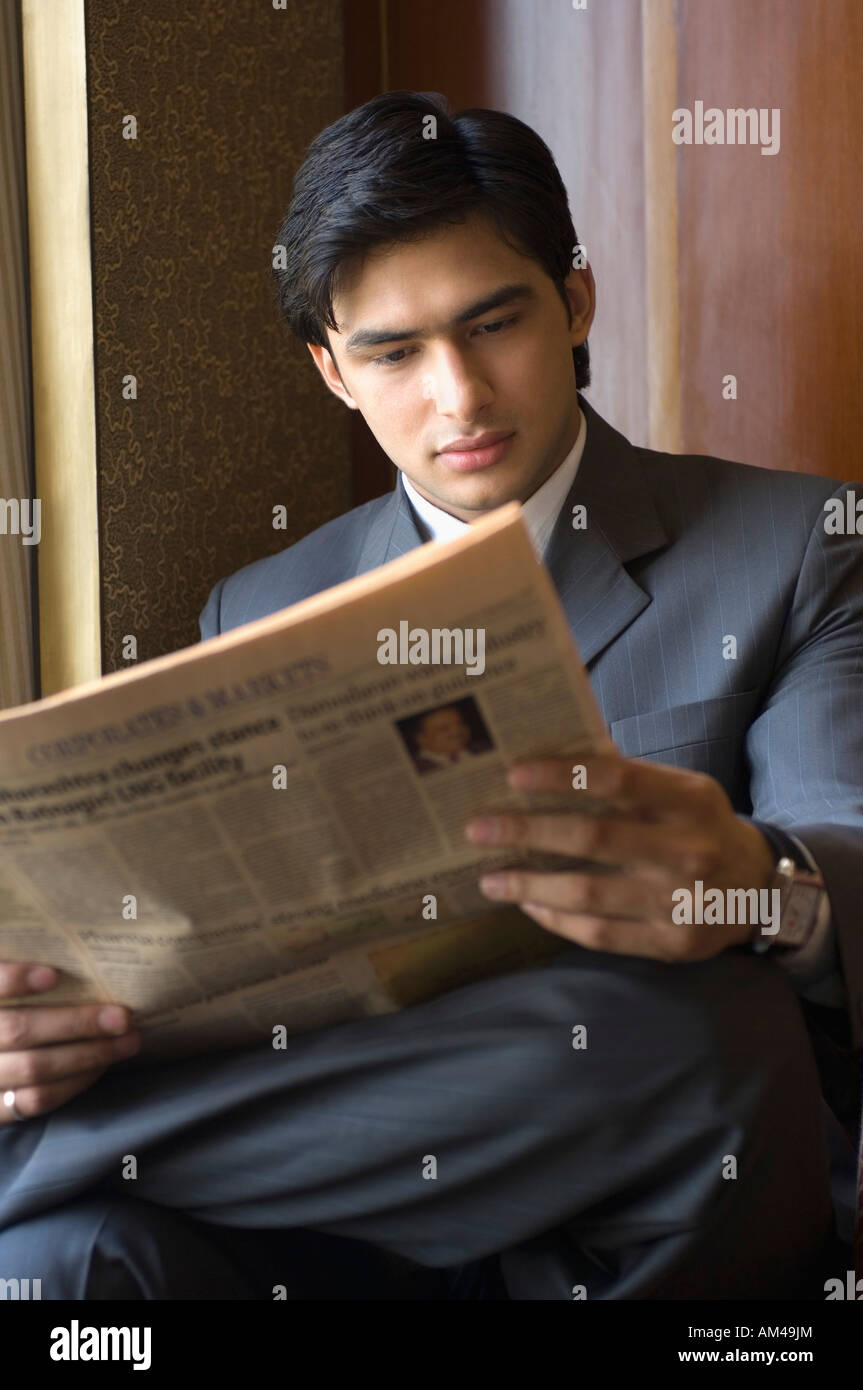 Newspaper hold man suit sit hi-res stock photography and images - Alamy