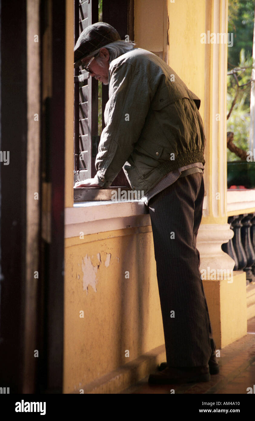 Old man contemplates life through a window in Macau Stock Photo - Alamy