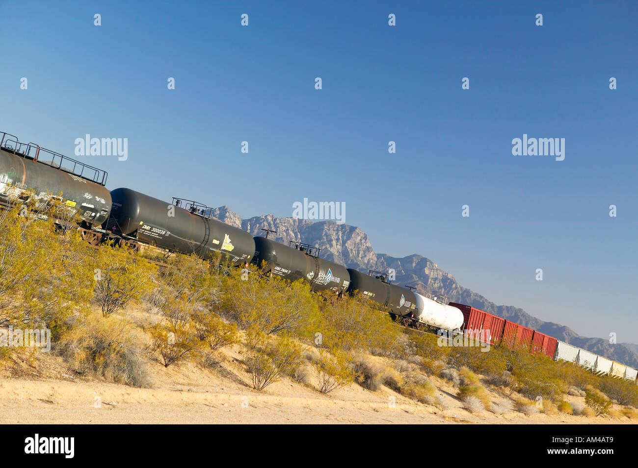 Freight train travels through desert and mountainous areas of Mojave ...