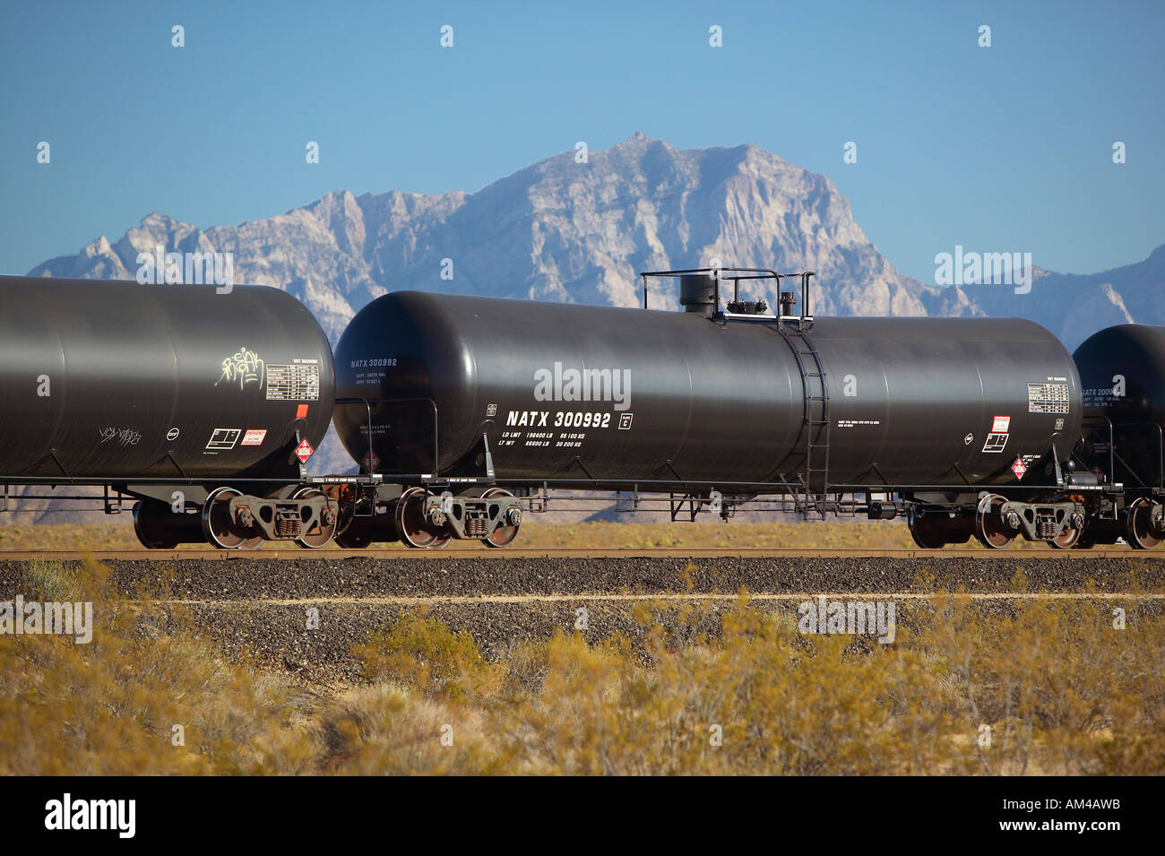 Freight train travels through desert and mountainous areas of Mojave ...