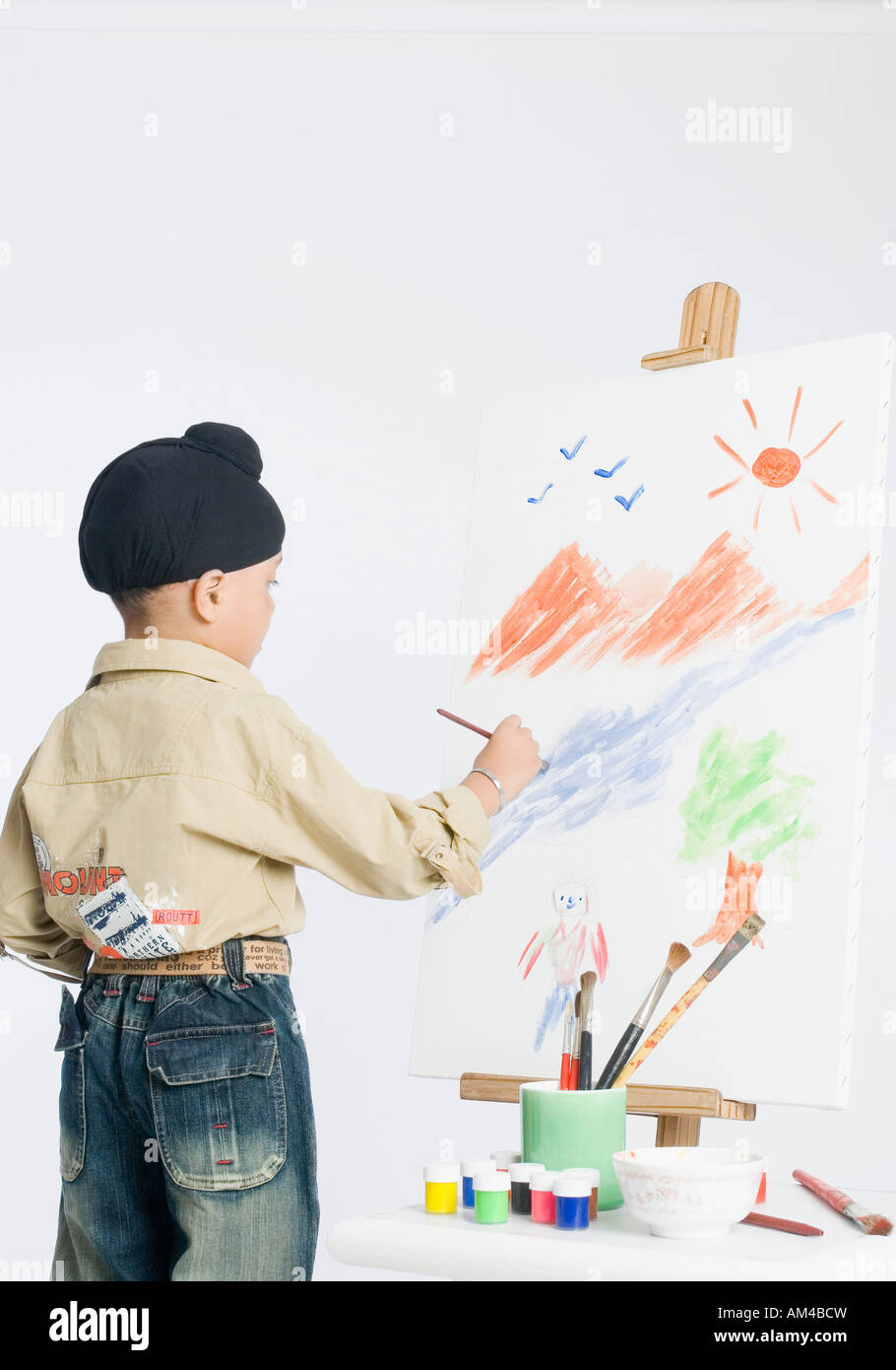 Rear view of a boy painting on an artist's canvas Stock Photo - Alamy