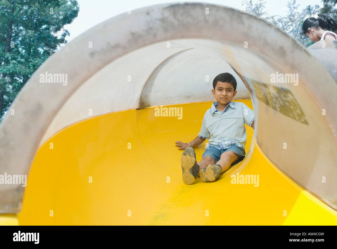 Portrait of a boy sliding on a slide Stock Photo - Alamy