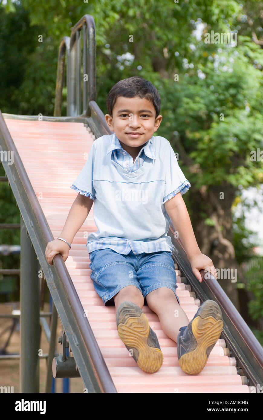 Portrait of a boy sliding on a slide Stock Photo - Alamy