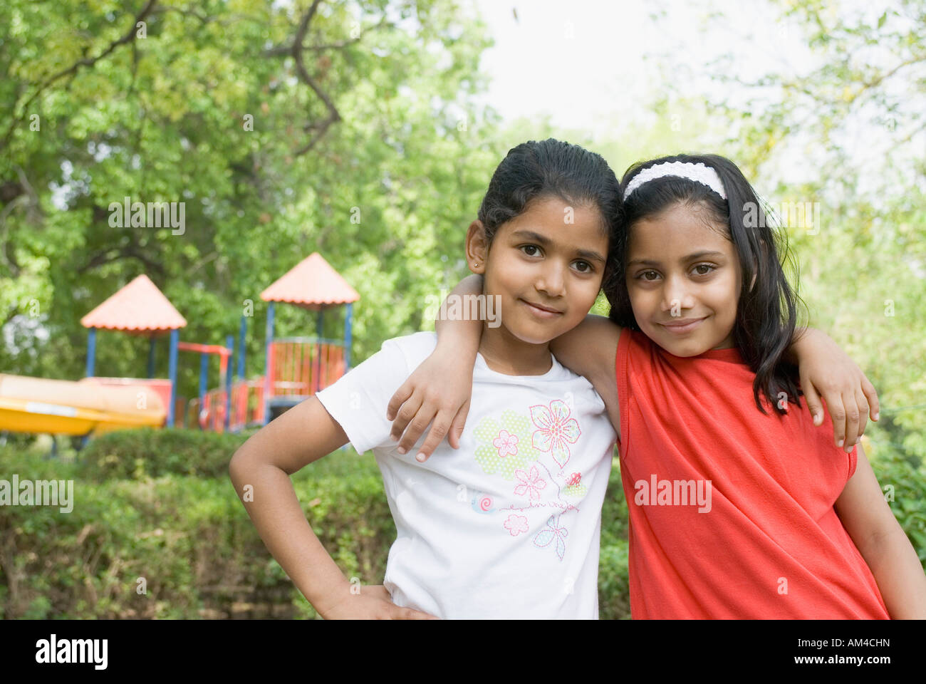 Portrait of two girls with their arms around each other Stock Photo - Alamy