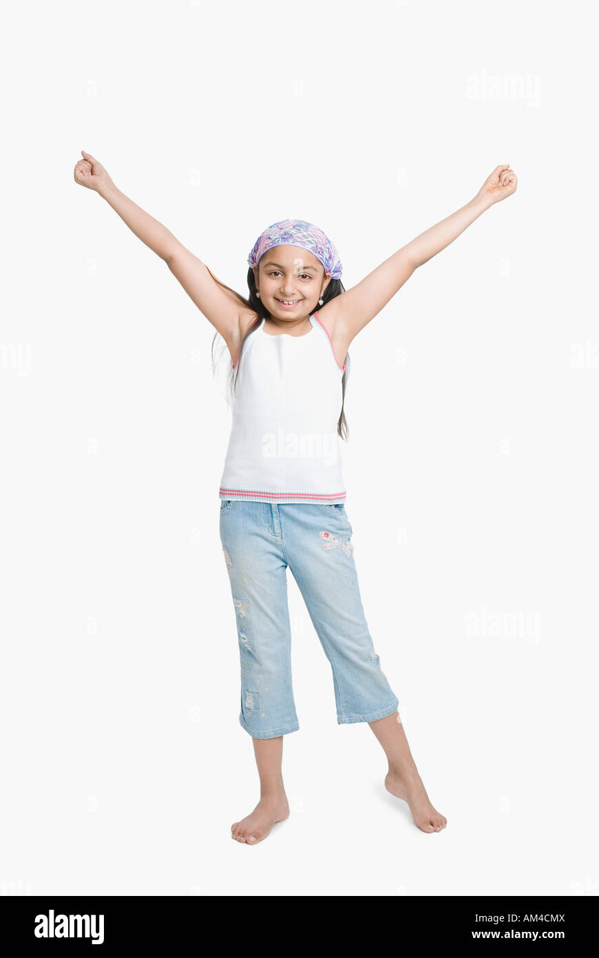 Portrait of a girl standing with her arms raised Stock Photo - Alamy