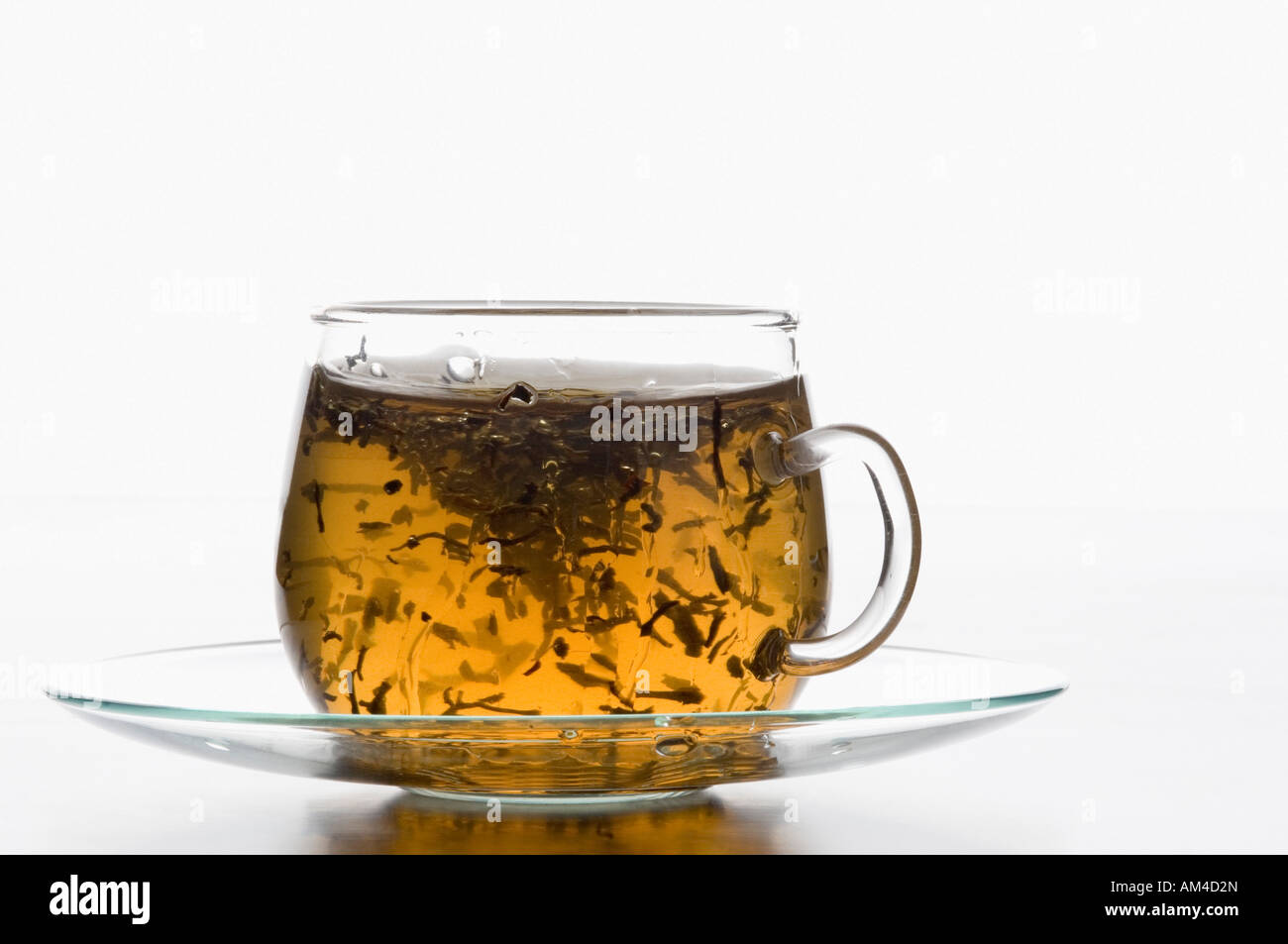 Tea leaves floating in a cup of herbal tea Stock Photo - Alamy