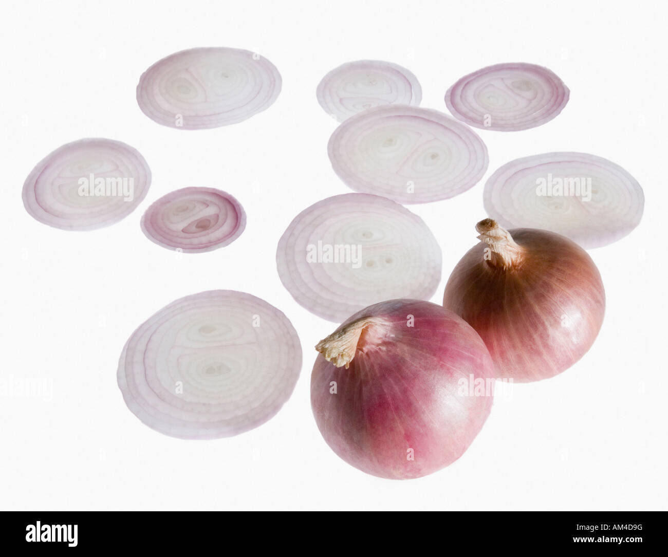 Close-up of two onions with slices Stock Photo - Alamy