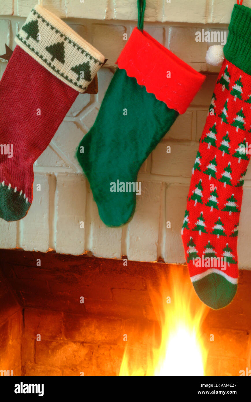 Christmas Stockings hung on the mantle with care. A fire burns in the ...