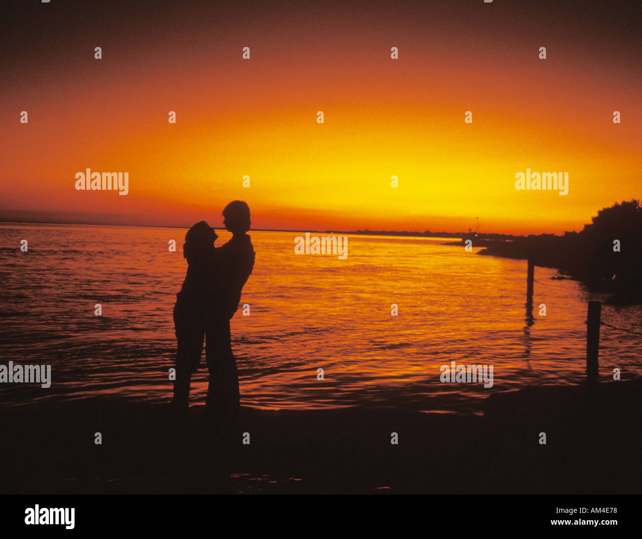Couple embrace on hill sunset hi-res stock photography and images - Alamy