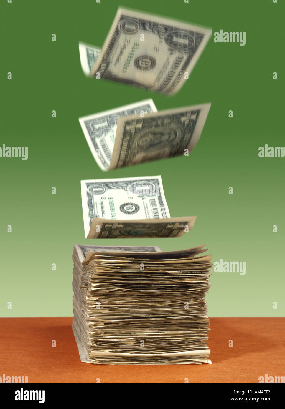 stack of American one dollar bills falling into a stack Stock Photo - Alamy