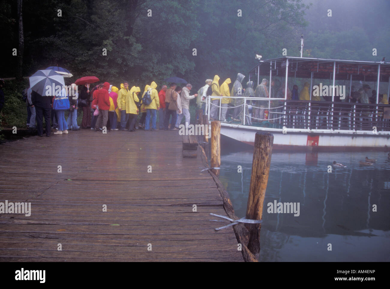 Visitors line up to board the ferry that crosses the largest lake ...