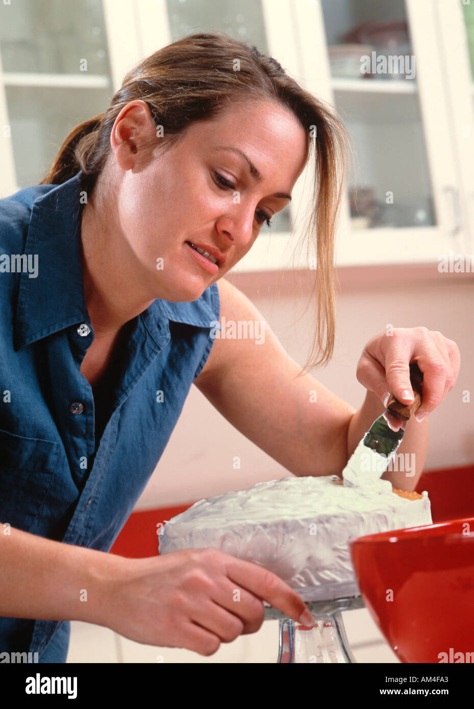 woman puts icing on birthday cake she has just baked Stock Photo - Alamy
