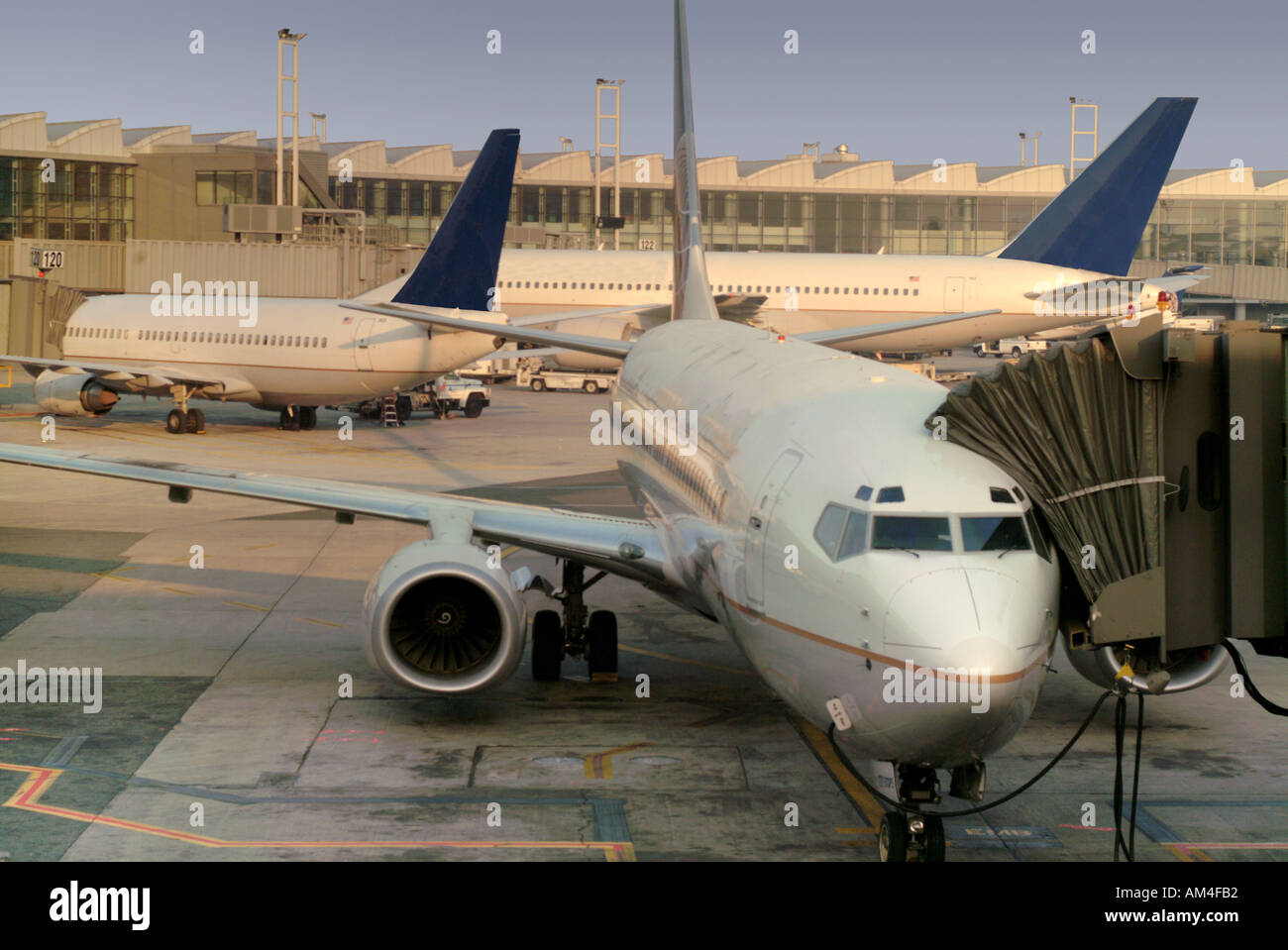 commercial jets at an airport gate takes on passengers through the jet ...