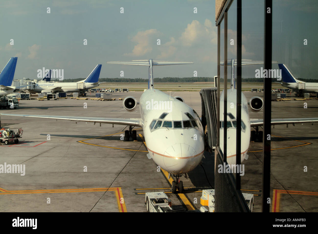 commercial jets at an airport gate takes on passengers through the jet ...