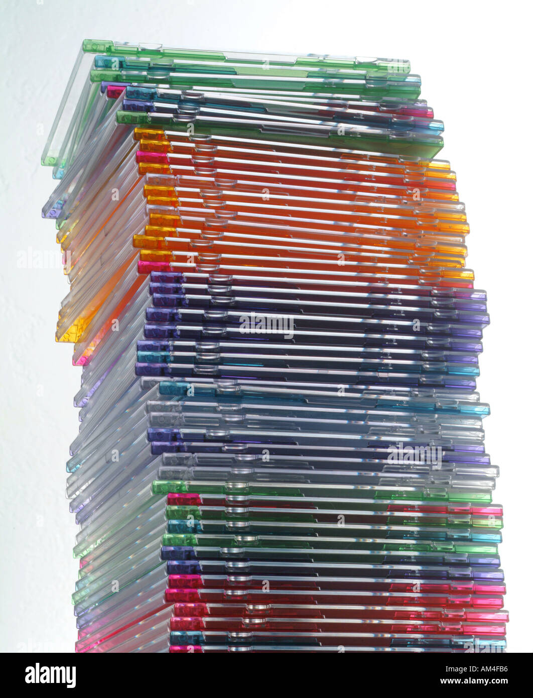 Colored CDs and jewel boxes stacked high Stock Photo - Alamy